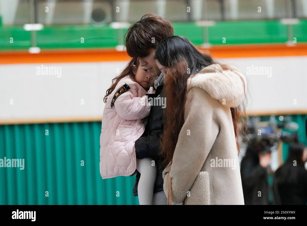 Mourners pray for the victims on a plane which skidded off a runway and ...