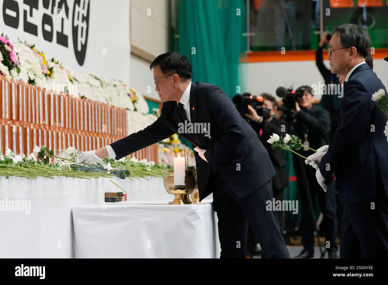 South Korea's acting President Choi Sang-mok places a flower for the victims on a plane which ...