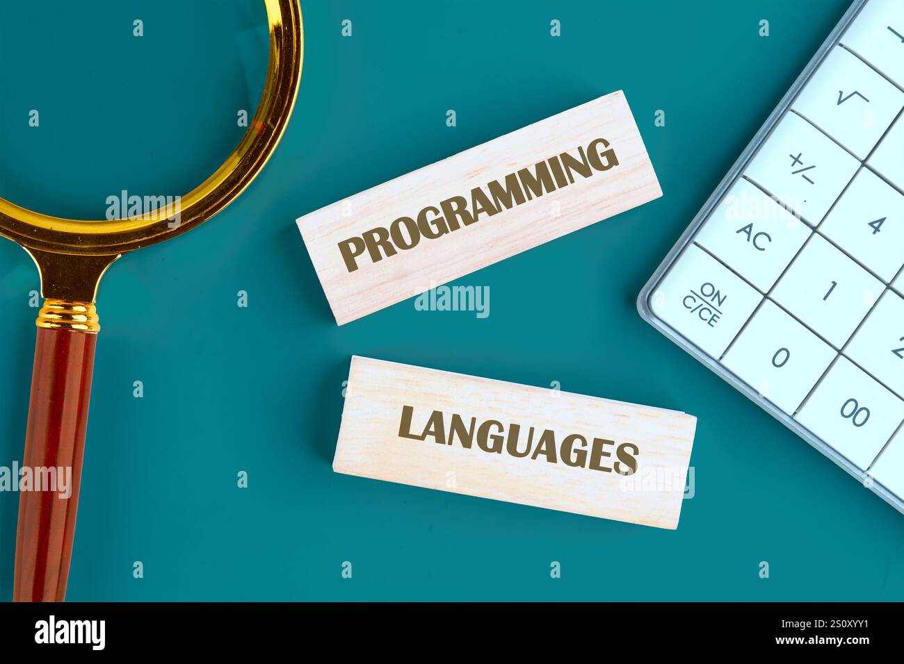 A magnifying glass and a calculator sit on a teal background next to ...