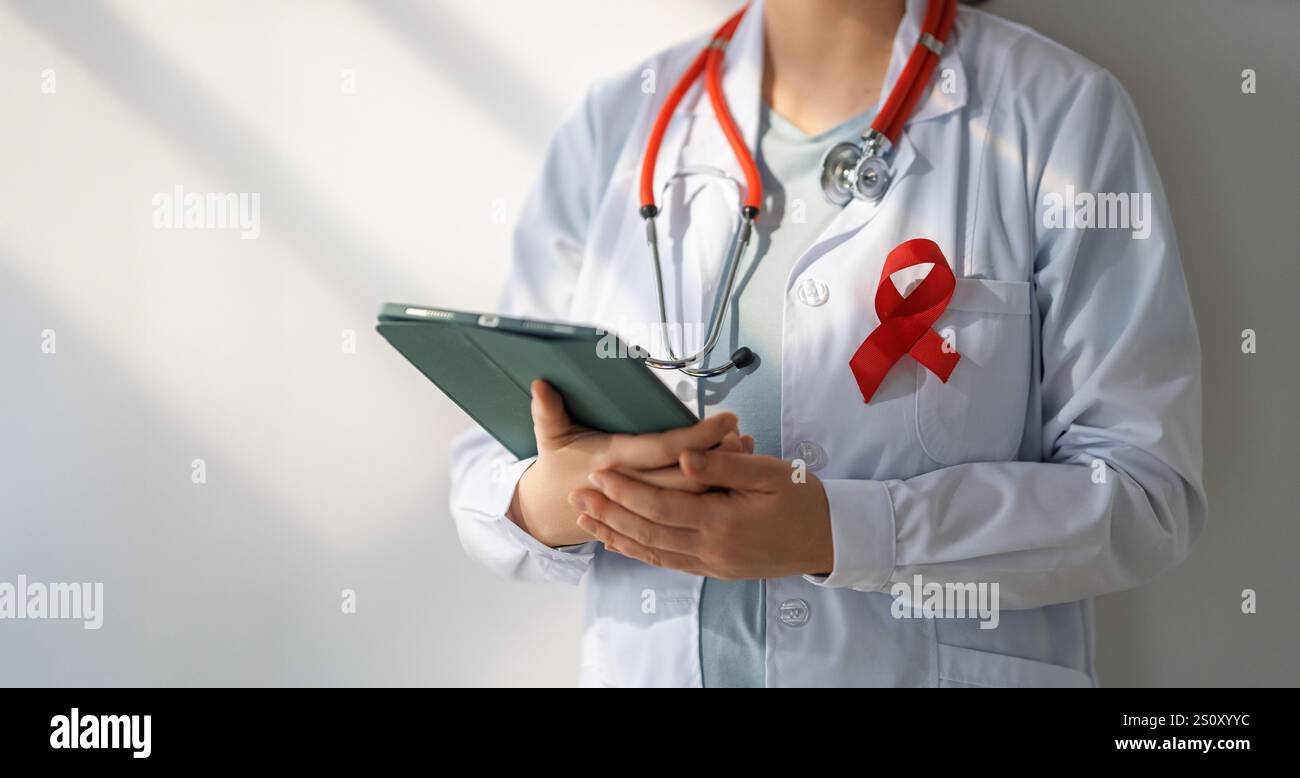 World Aids Day. Red ribbon in the hands close up Stock Photo - Alamy