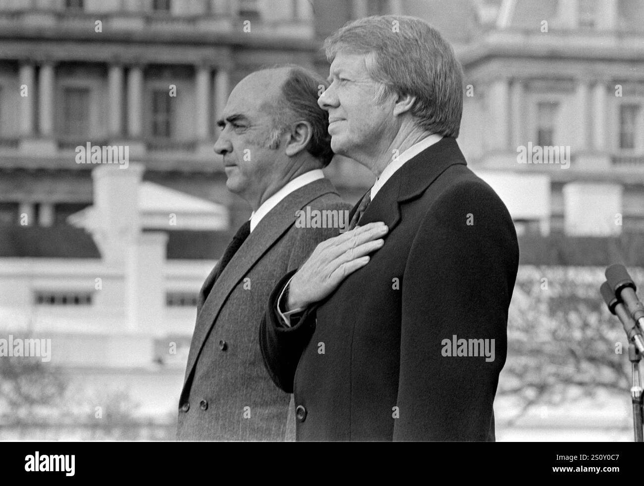 United States President Jimmy Carter, right, stands at attention as he ...