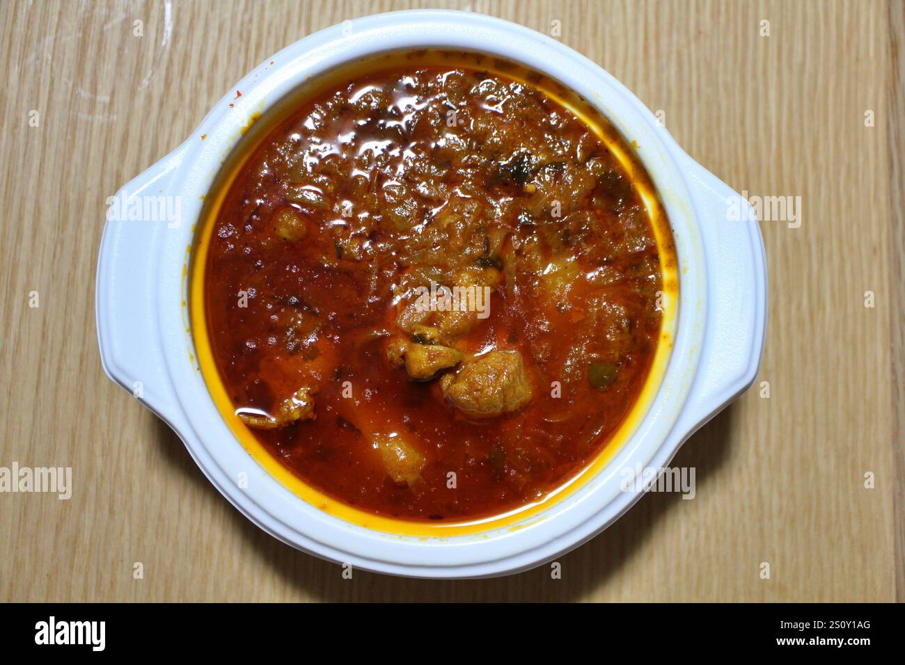 Food delivery: chicken vindaloo (Goan curry Stock Photo - Alamy