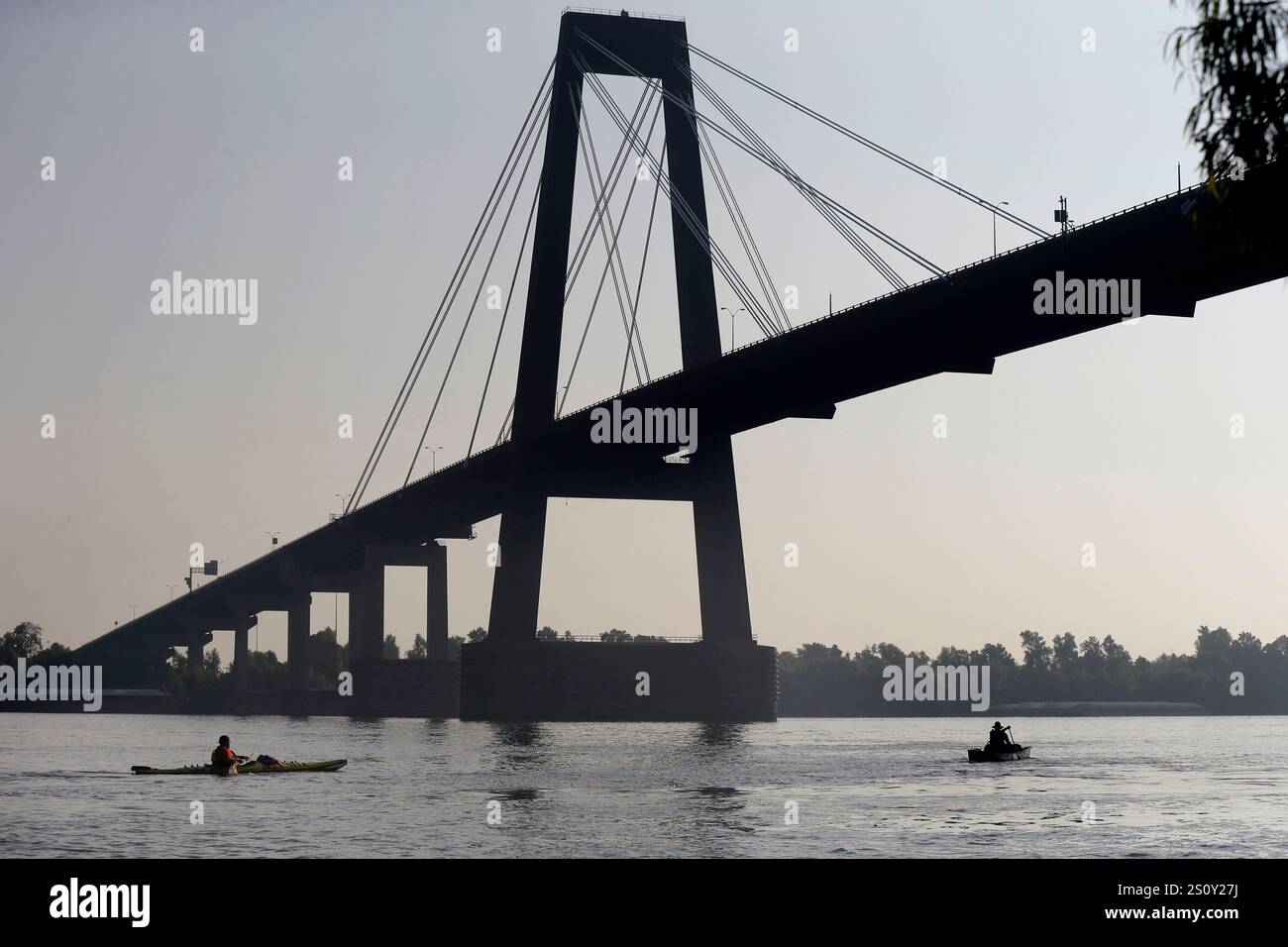 FILE - Two people canoe under the Hale Boggs Memorial Bridge in the ...