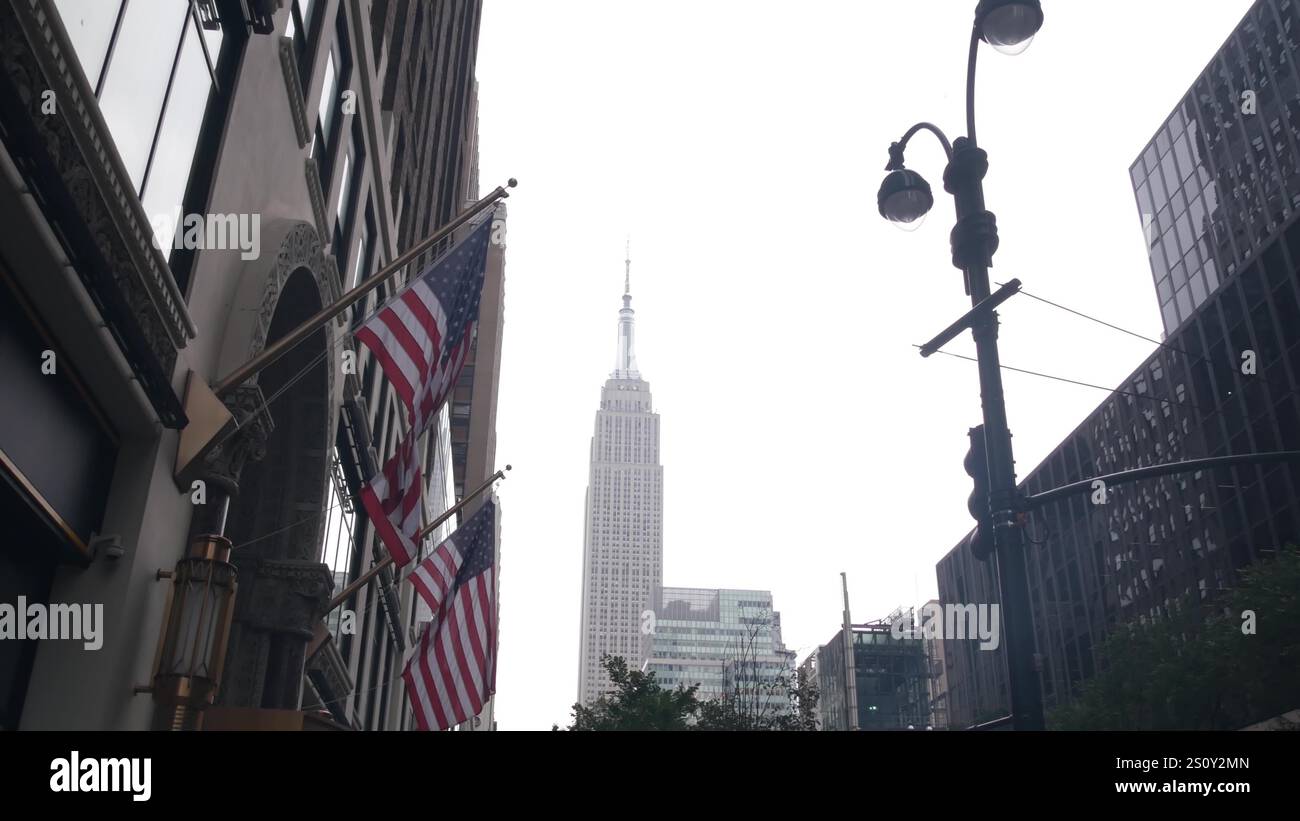 New York, american flag waving. Empire State Building. Manhattan ...