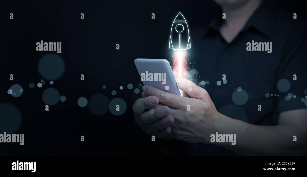 Startup business concept. Businessman with his smartphone launches a ...
