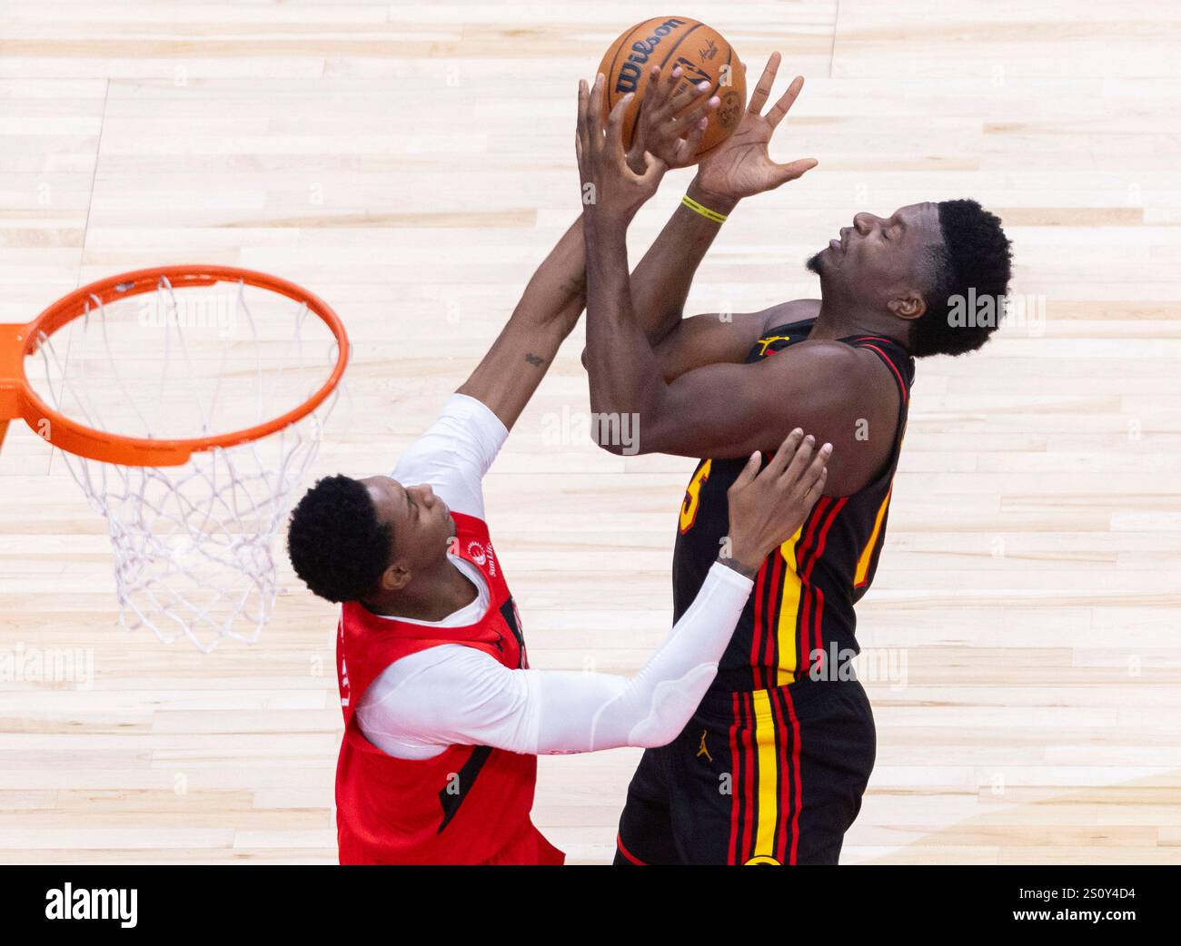 Toronto, Canada. 29th Dec, 2024. RJ Barrett (L) of Toronto Raptors vies with Clint Capela of ...