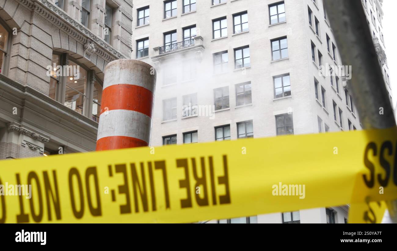 Steam vapor vented on New York City street, orange vapour tube stack ...