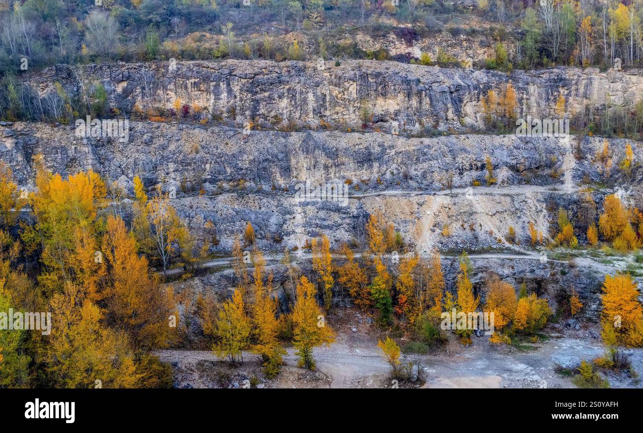 Autumn landscape with ledges of an old limestone quarry, horizontal ...