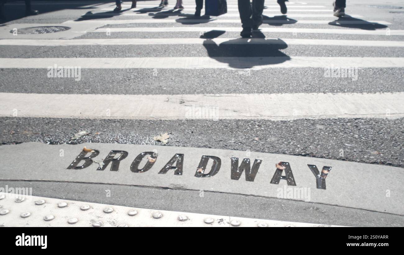 Broadway street sign, people on pedestrian zebra crossroad. New York ...