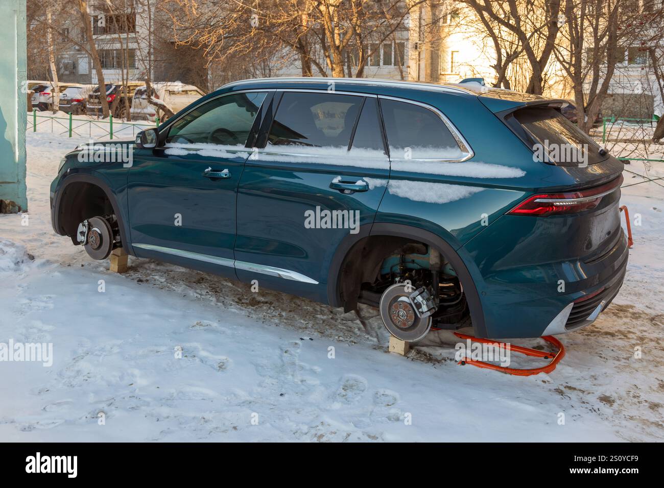 blue car with no wheels is parked in a parking lot Stock Photo - Alamy
