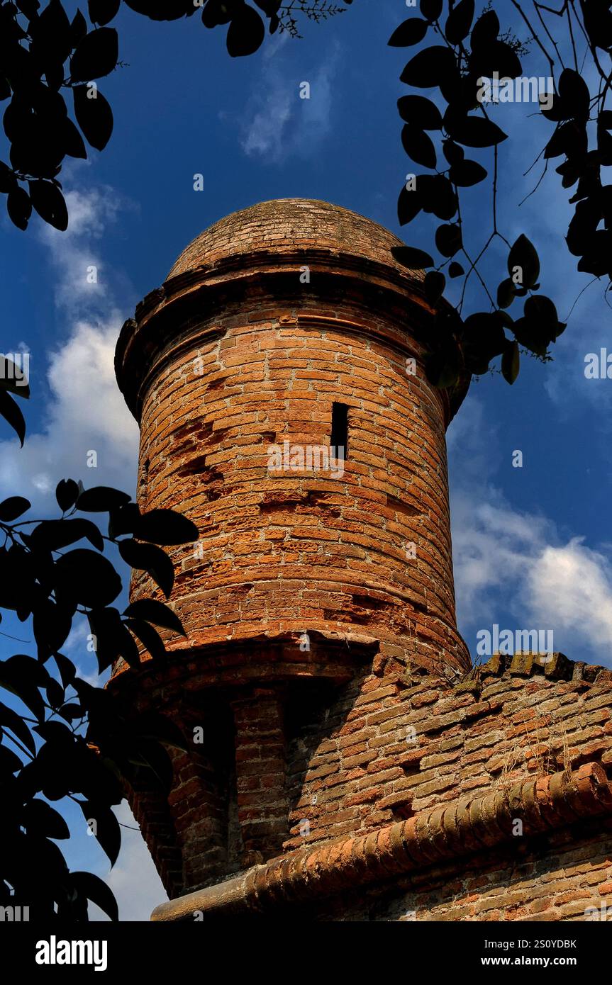 Cylindrical red brick domed cupola or turret, seen amid silhouette ...