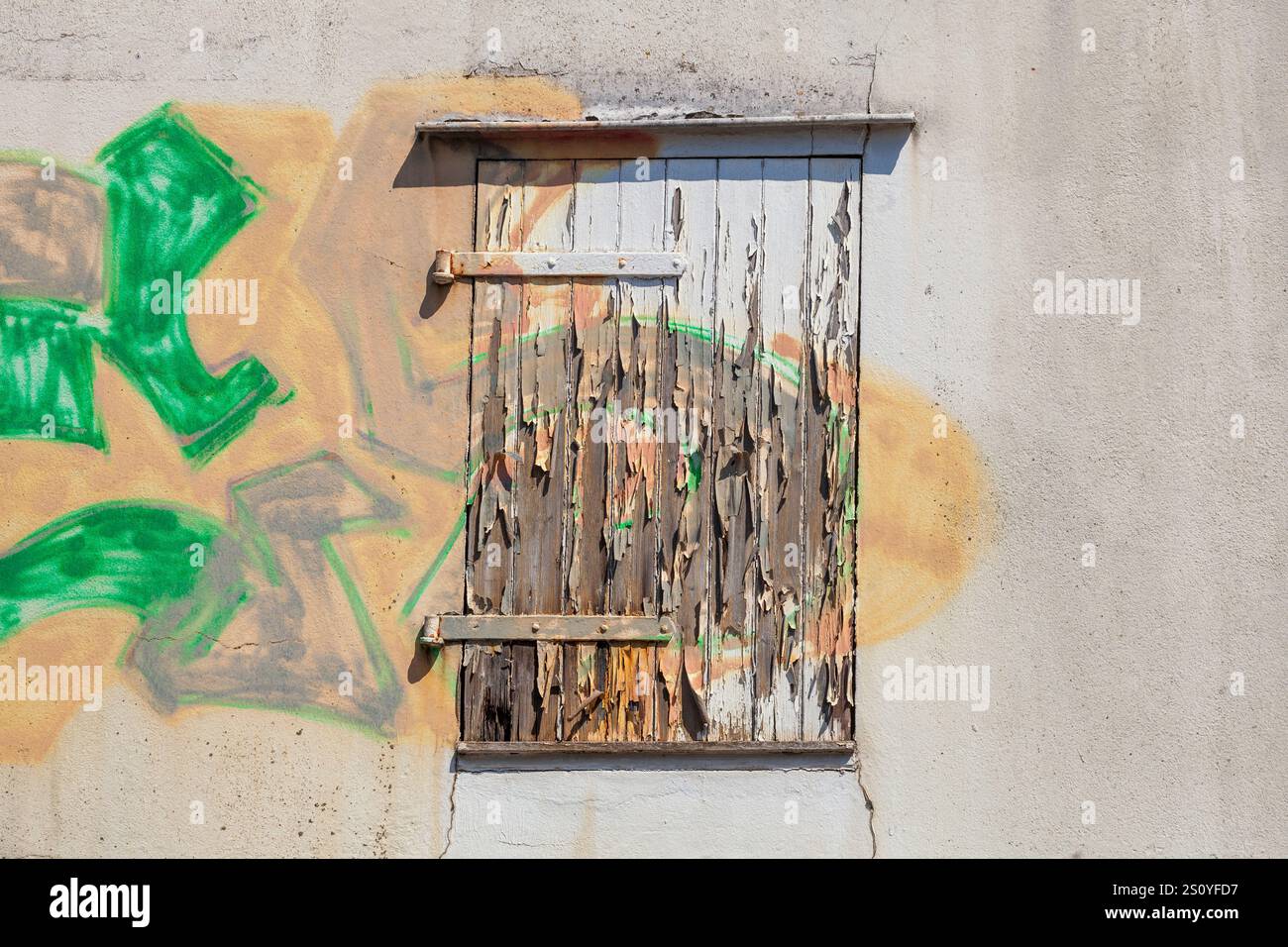 Old weathered shutter with wooden hatch on a white house wall, Germany ...