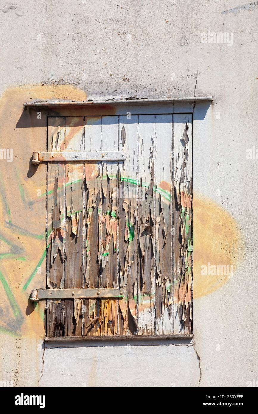 Old weathered shutter with wooden hatch on a white house wall, Germany ...