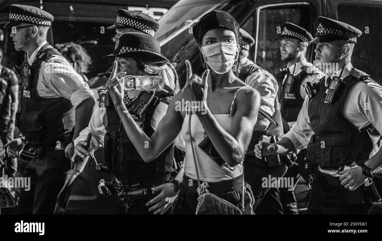 Police rush past a protester at a Black Lives Matter protest in London ...