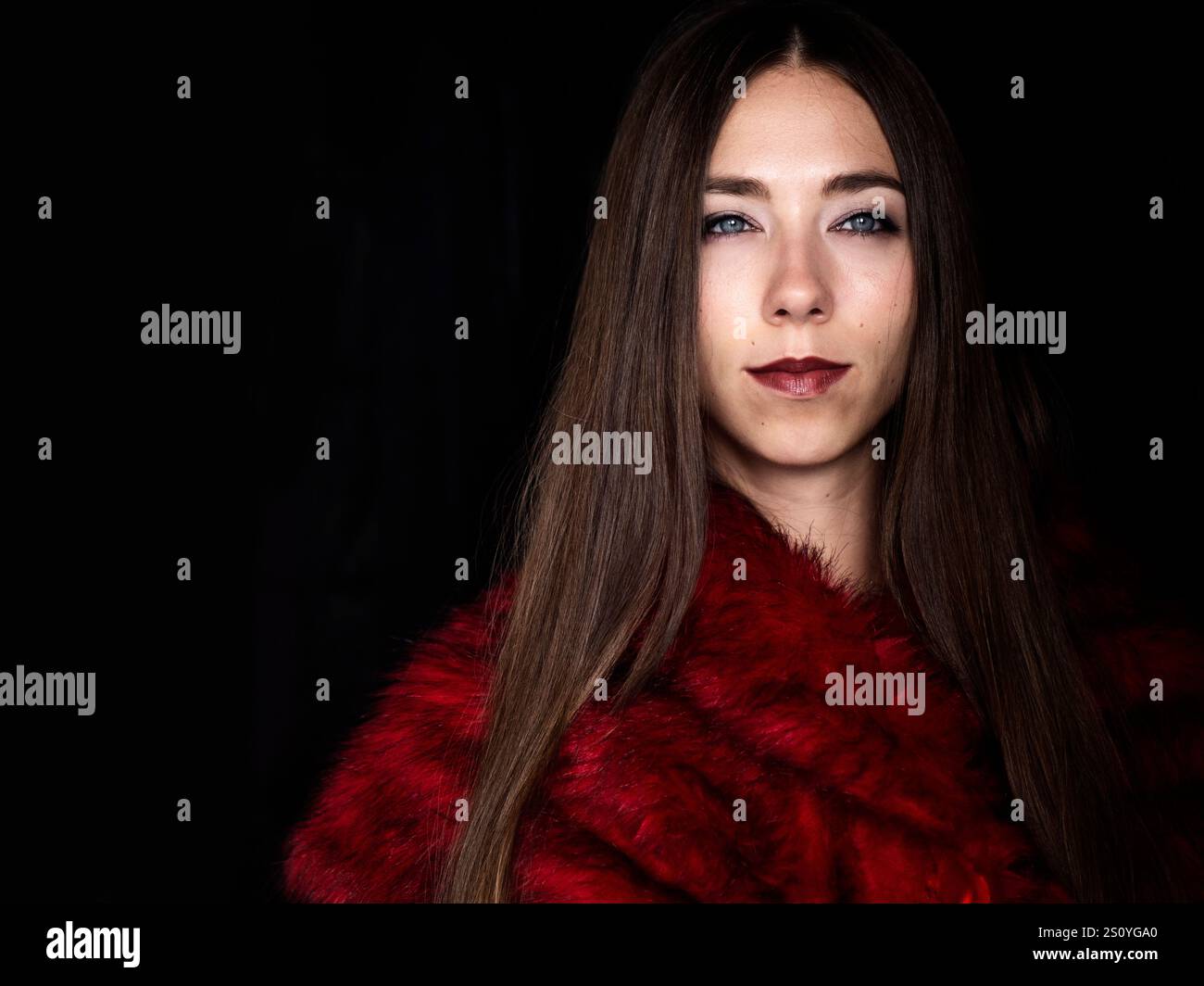 Beautiful woman wearing red faux fur Stock Photo - Alamy