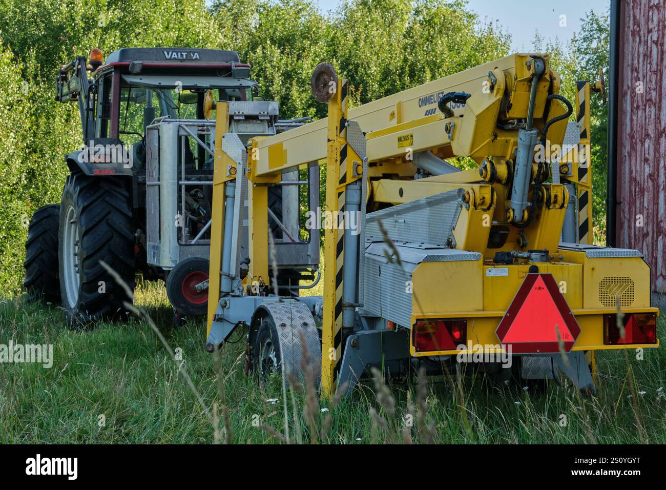 Tractor with lifting platform on the trailer hitch Stock Photo - Alamy