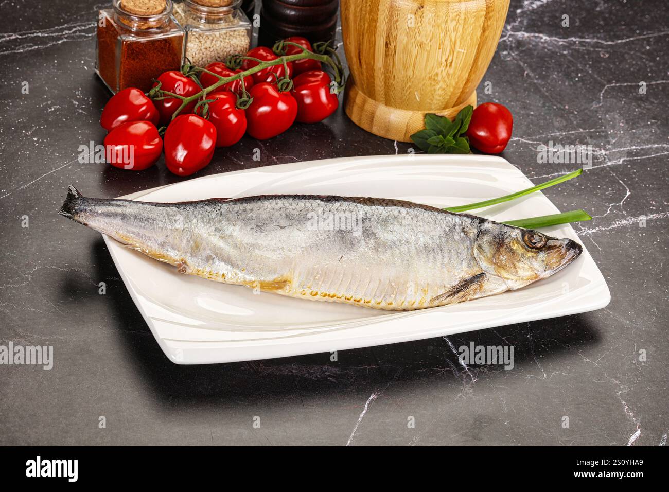 Whole raw salted herring fish in the plate Stock Photo - Alamy