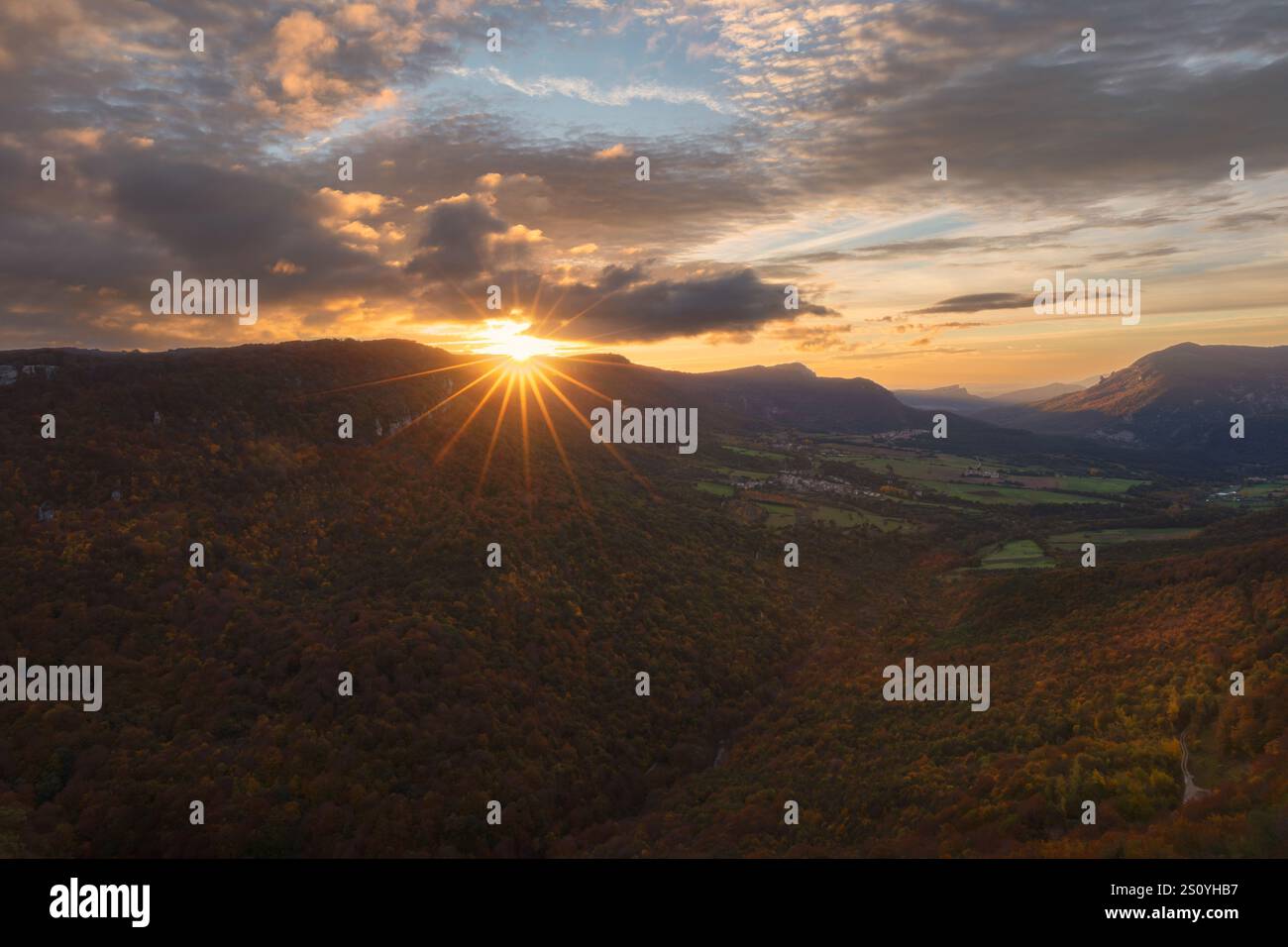 Sunrise, sun spikes over the forest in Navarra Stock Photo - Alamy