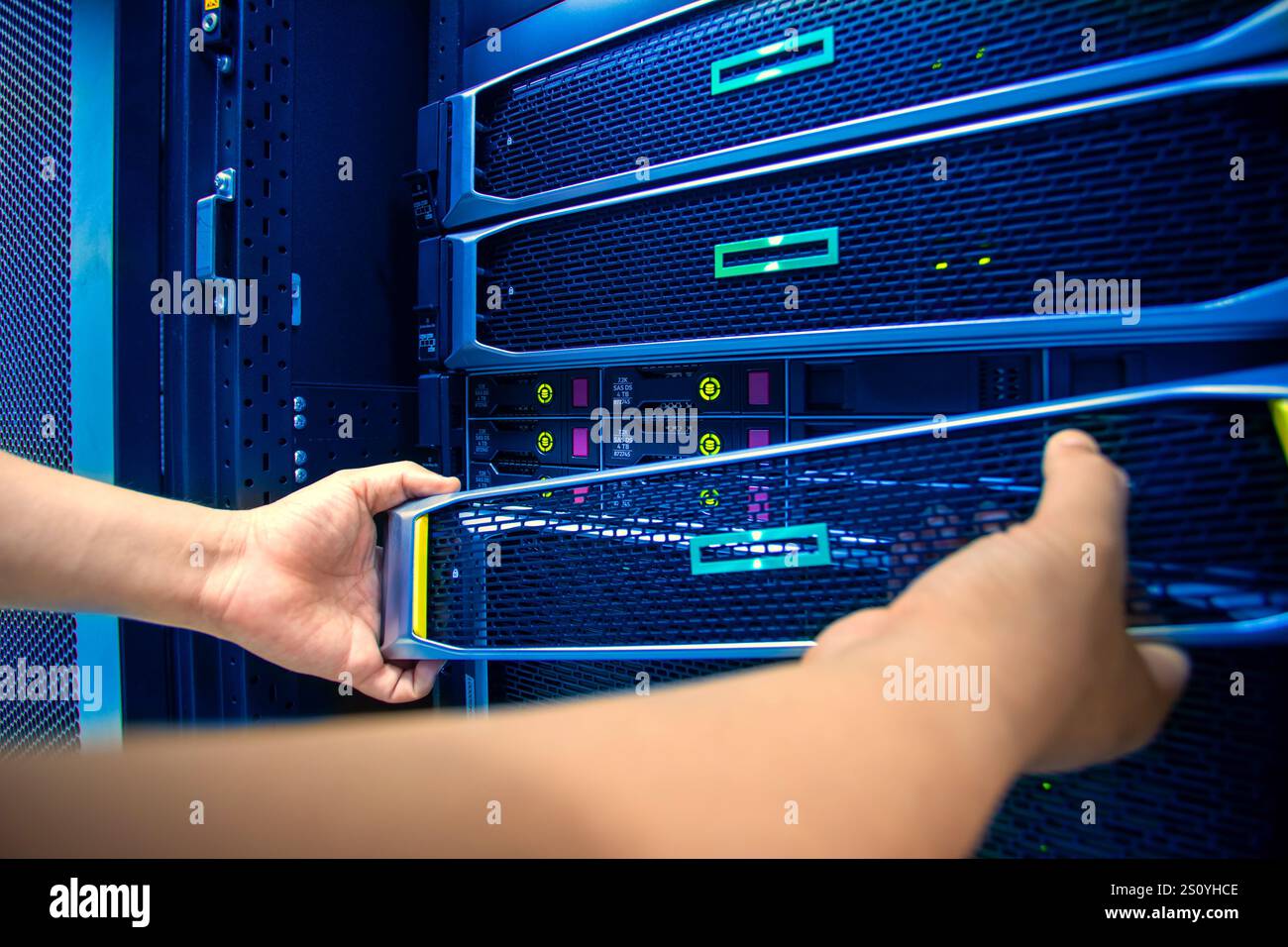 Man fixing server in data center room Stock Photo - Alamy