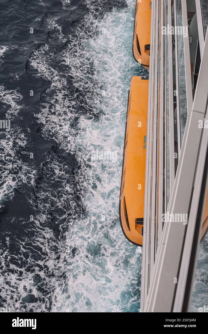 Looking overboard the ship into the ocean lifeboats Stock Photo - Alamy