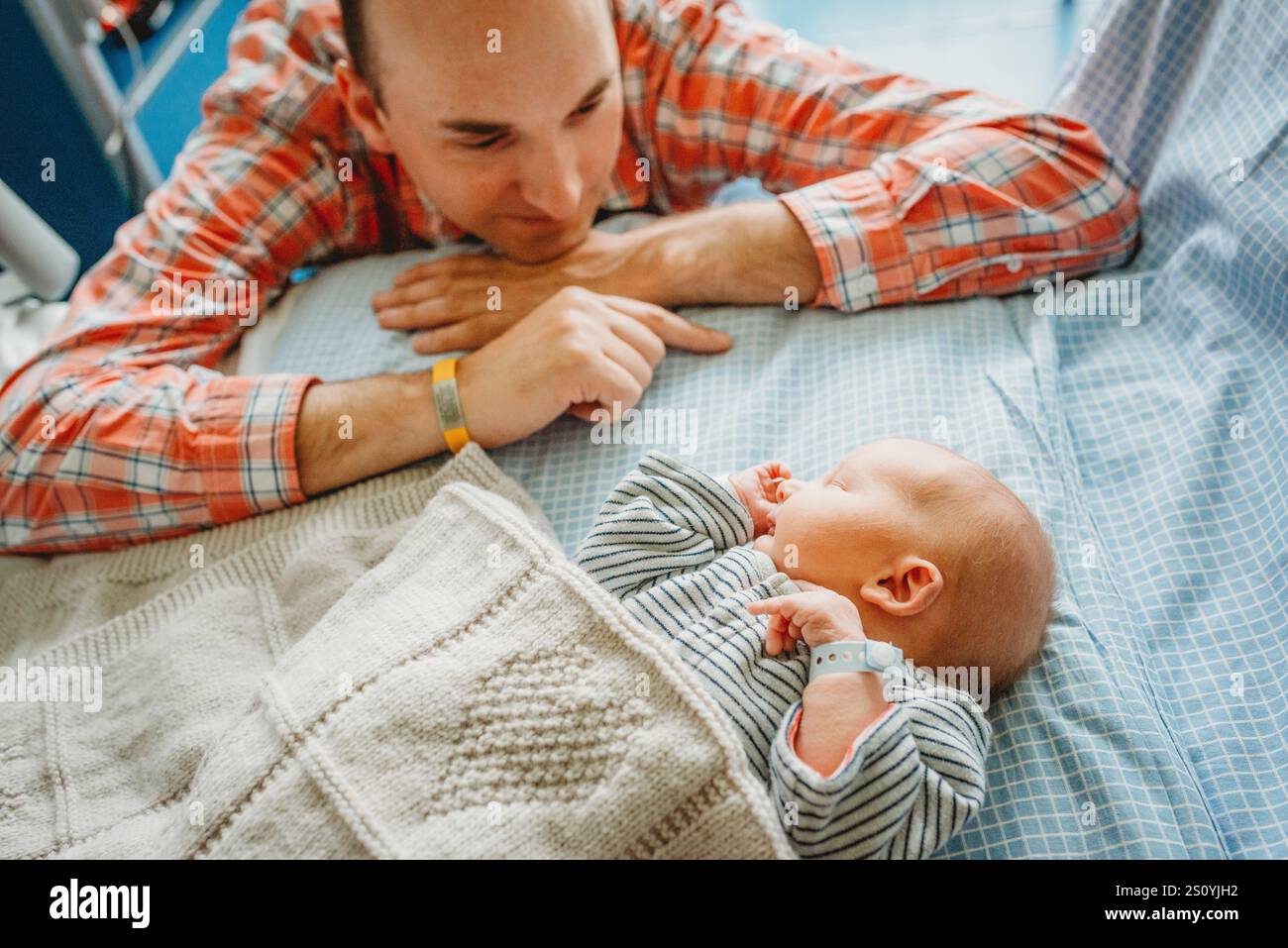 Father dad watching newborn baby boy sleeping at hospital Stock Photo ...