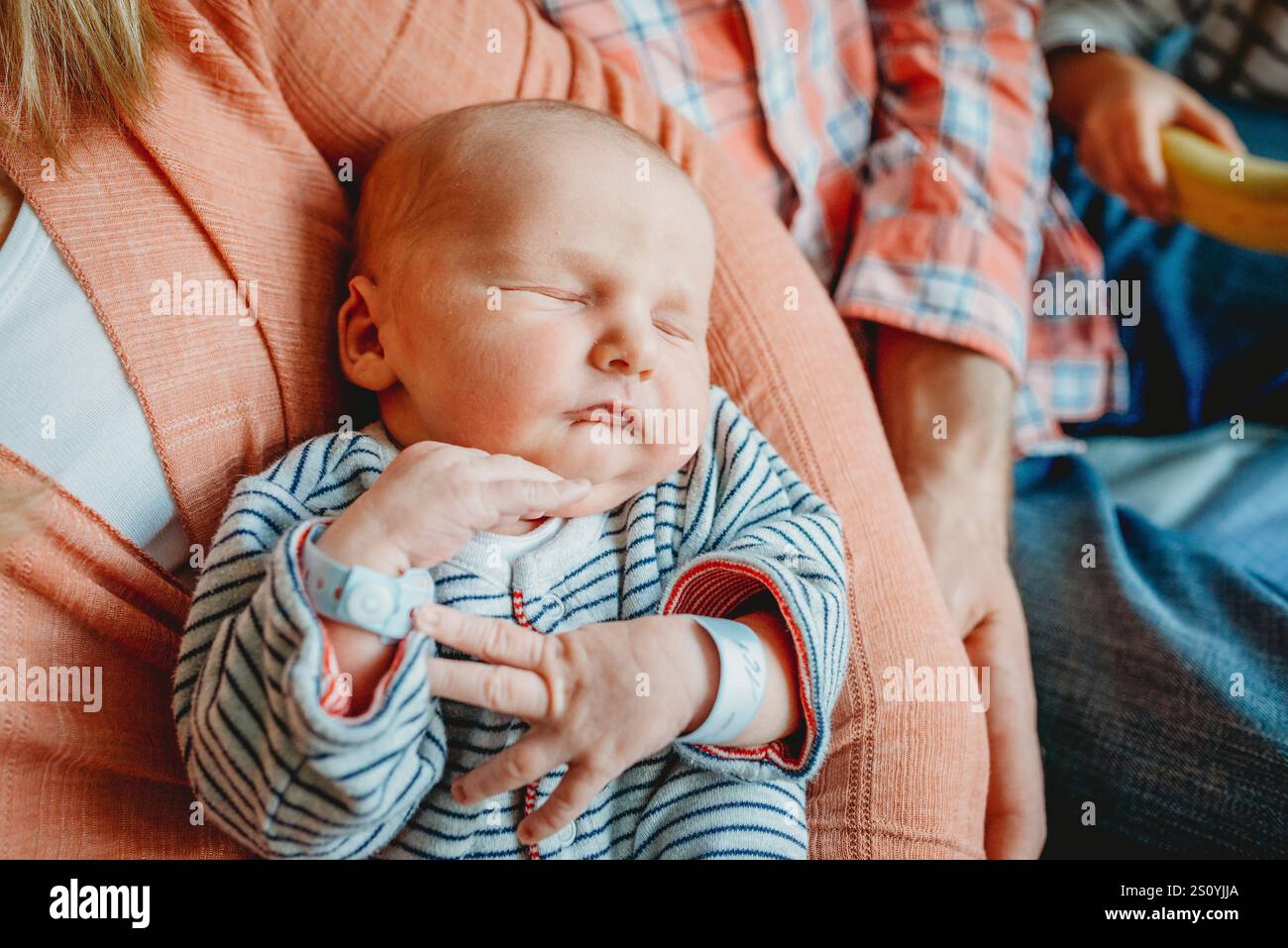 Newborn baby sleeping on mom arms at hospital after birth Stock Photo ...