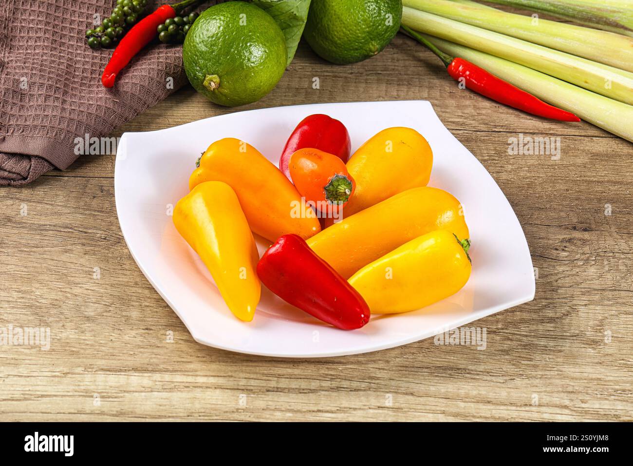 Small baby red and yellow bell pepper heap Stock Photo - Alamy