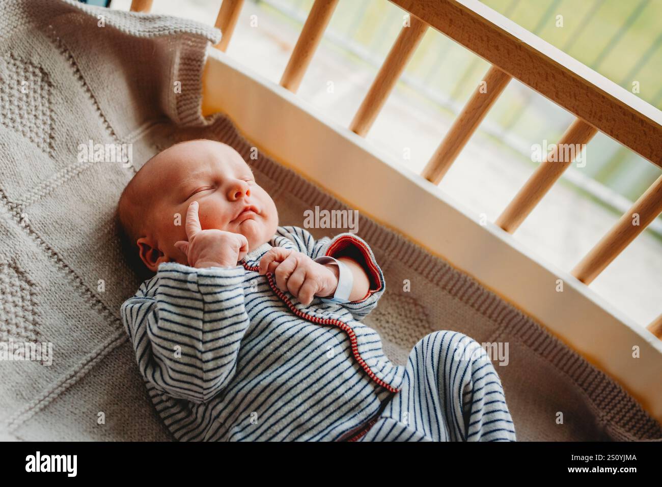 Newborn baby sleeping in hospital crib bassinet after birth Stock Photo ...