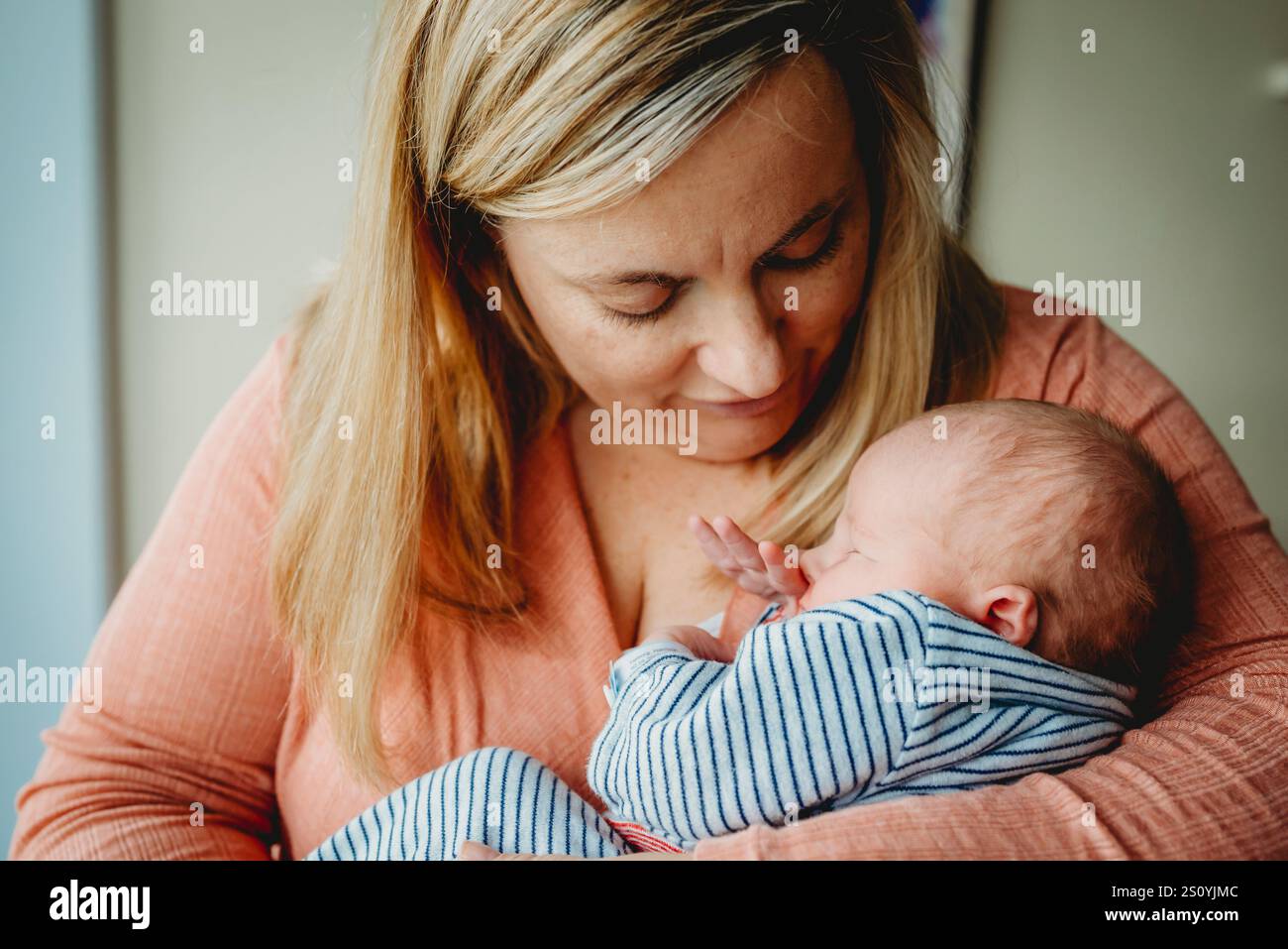 Newborn baby sleeping on mom arms at hospital after birth Stock Photo ...