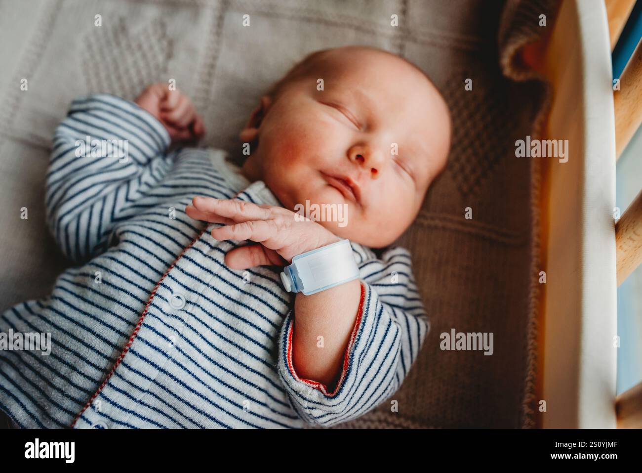 Newborn baby sleeping in hospital crib bassinet after birth Stock Photo ...