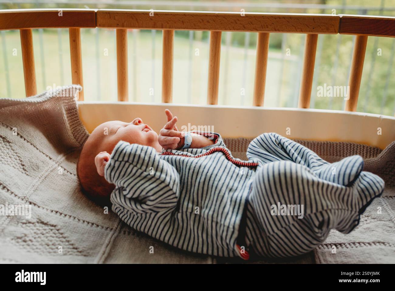 Newborn baby sleeping in hospital crib bassinet after birth Stock Photo ...