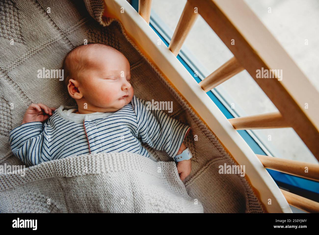 Newborn baby sleeping in hospital crib bassinet after birth Stock Photo ...
