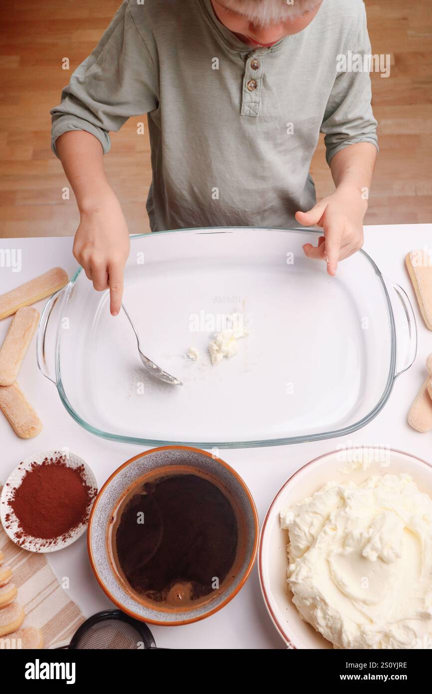 A kidâ€™s touch in dessert preparation Stock Photo - Alamy