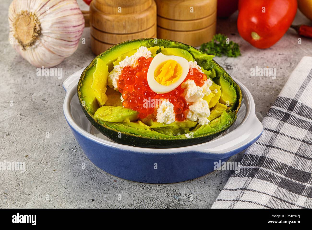 Avocado with red caviar and quil egg and soft cheese Stock Photo - Alamy