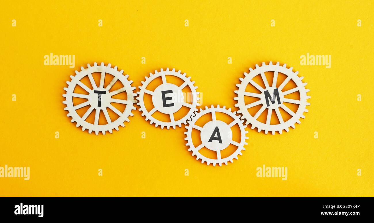Interconnected gears and the word team. Teamwork concept Stock Photo ...