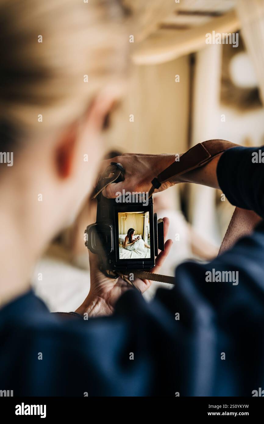 Photographer capturing a mother and baby through a camera's screen ...