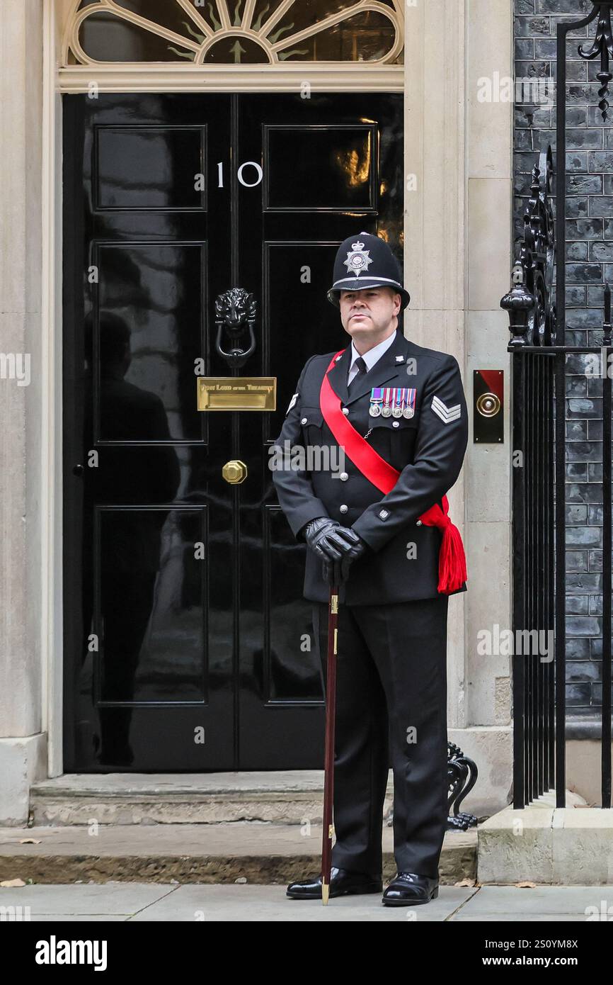 Metropolitan Police officer in ceremonial uniform and medals outside 10 ...