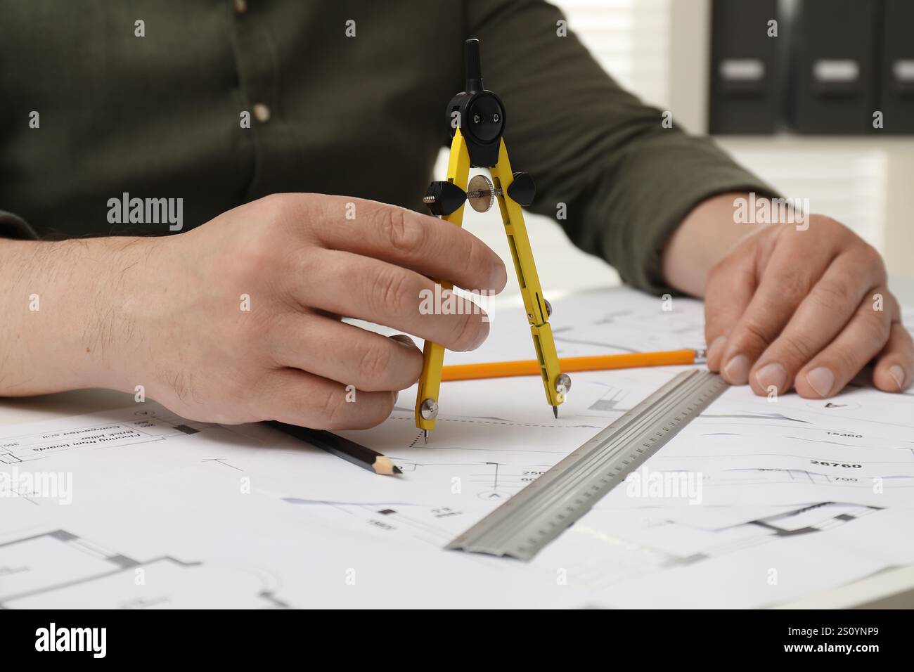 Architect working with project, closeup. Different technical drawings on table Stock Photo - Alamy