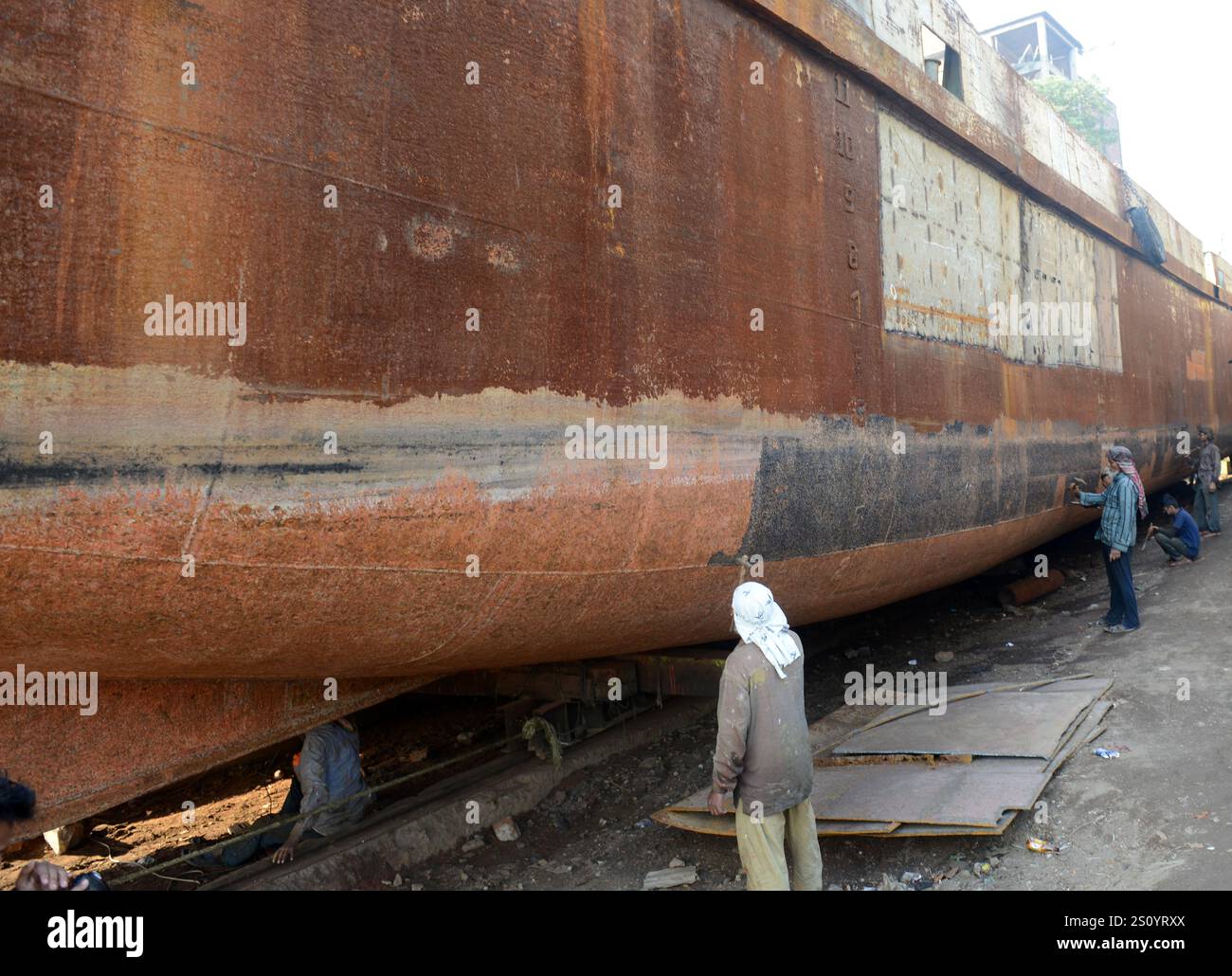 Bangladeshi men working on ships at shipyard by the Buriganga river in ...