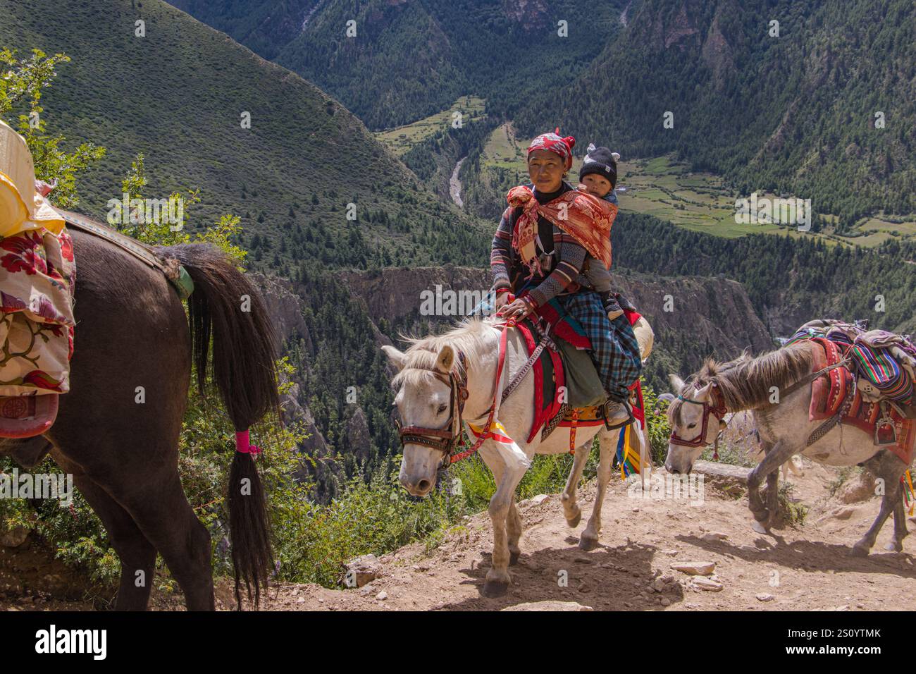 Dolpa people ride horses through a rugged terrain to go to the Shey ...