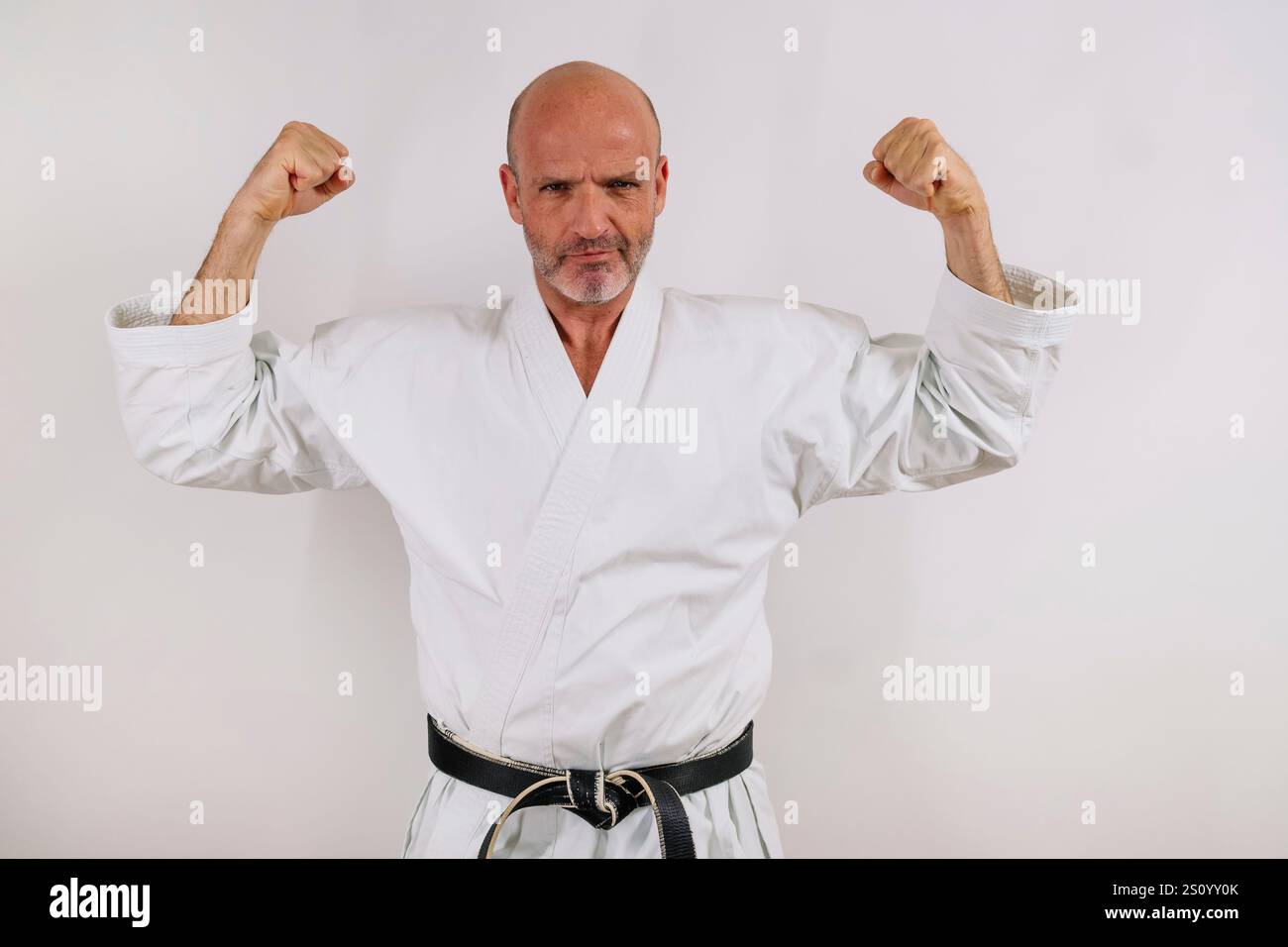 Karate master showing his arm muscles Stock Photo - Alamy