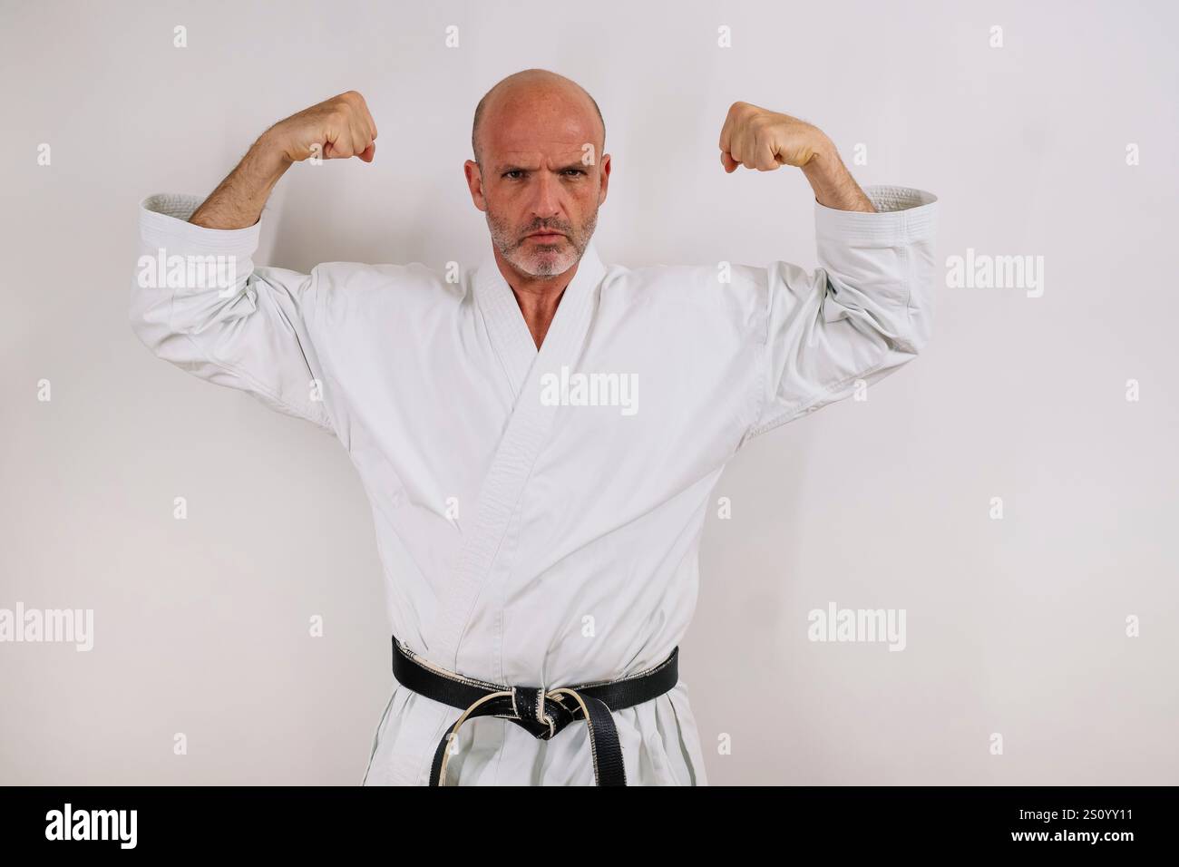 Karate master showing his arm muscles Stock Photo - Alamy