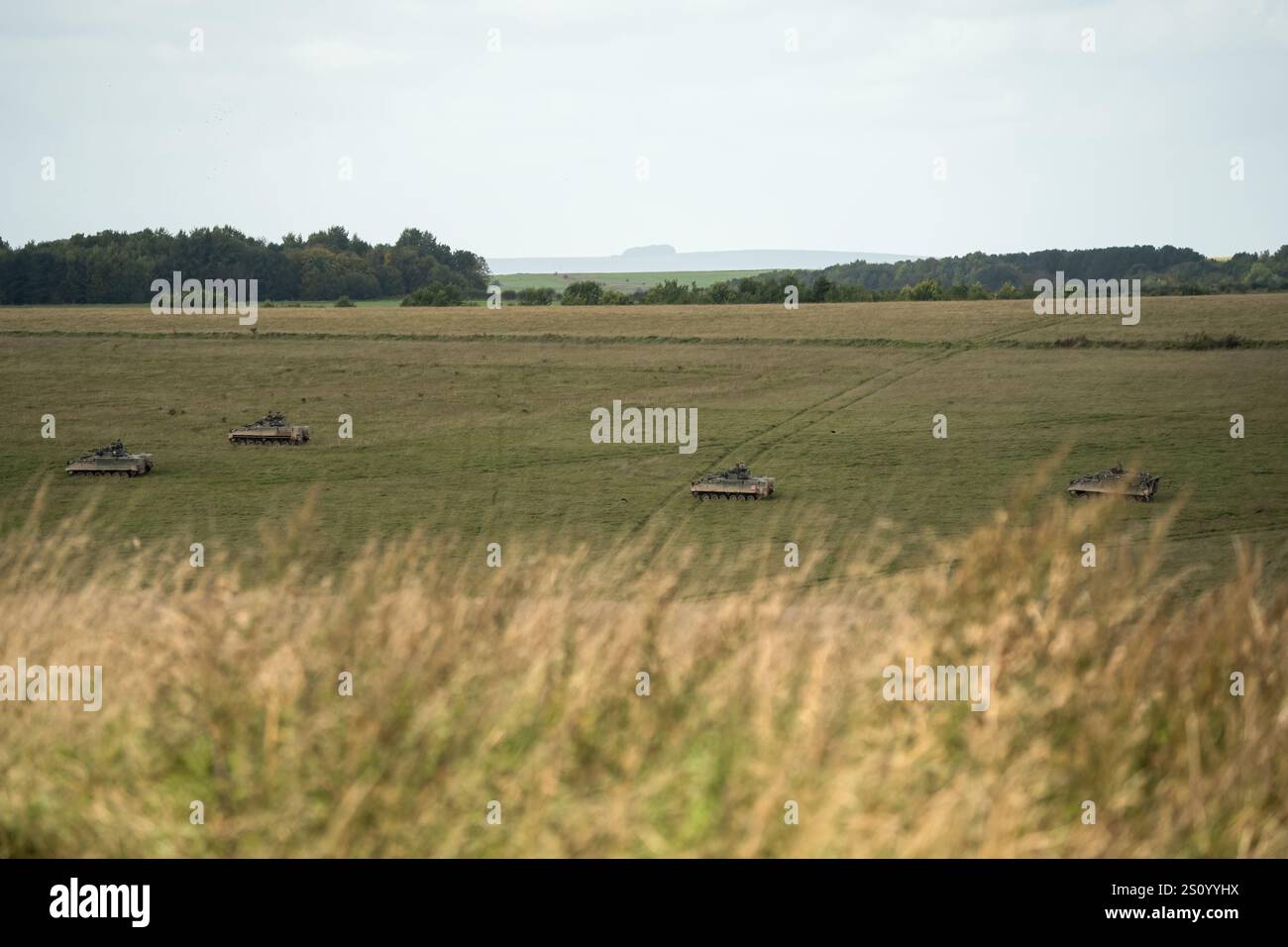 a squadron of British army Warrior FV510 IFVs in action on a military ...