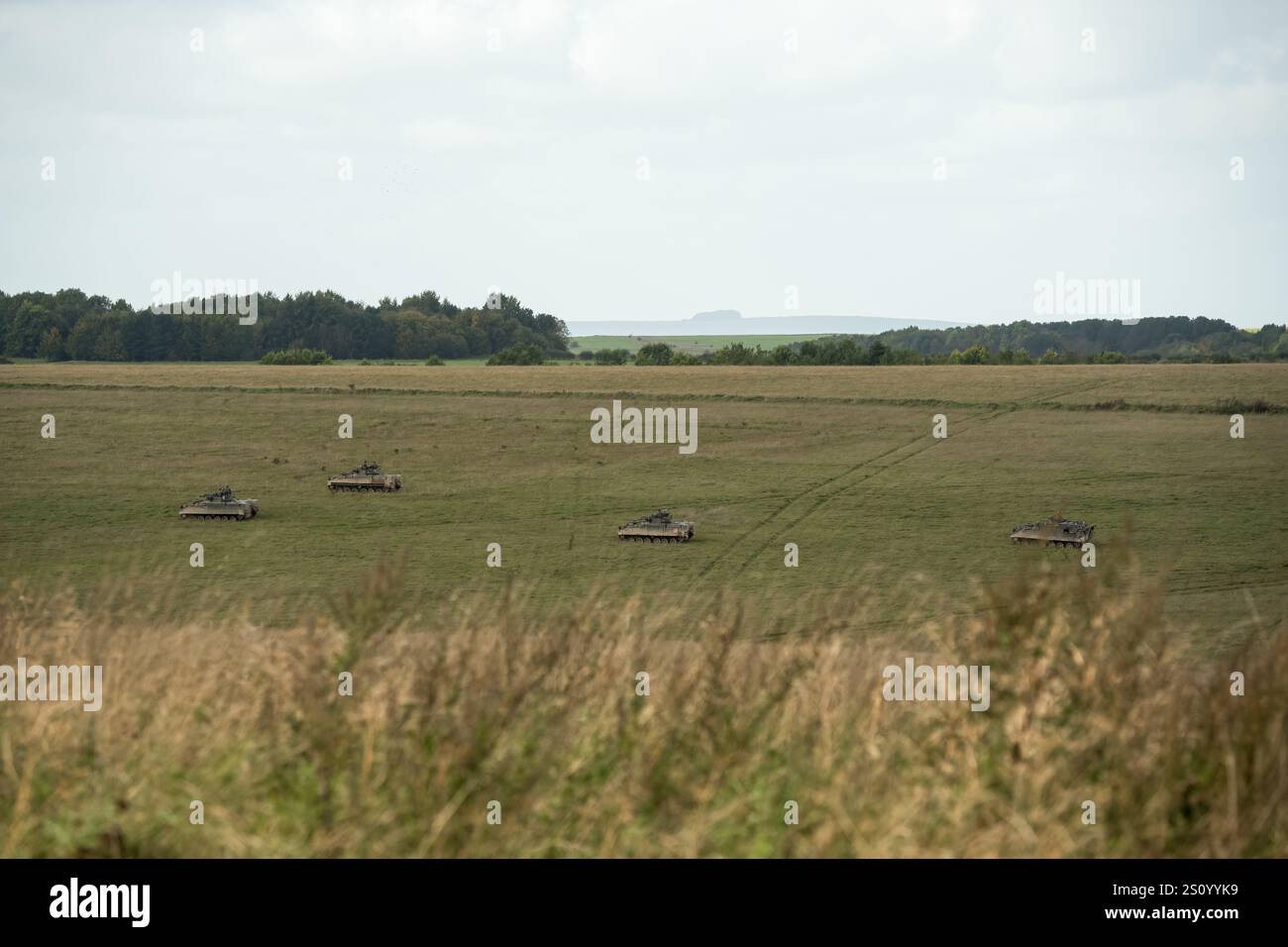 a squadron of British army Warrior FV510 IFVs in action on a military ...