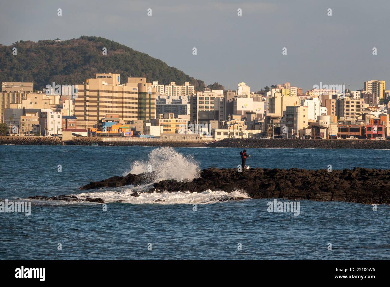 Jeju island, Dec 30, 2024 : A man fishes with a fishing pole on the ...