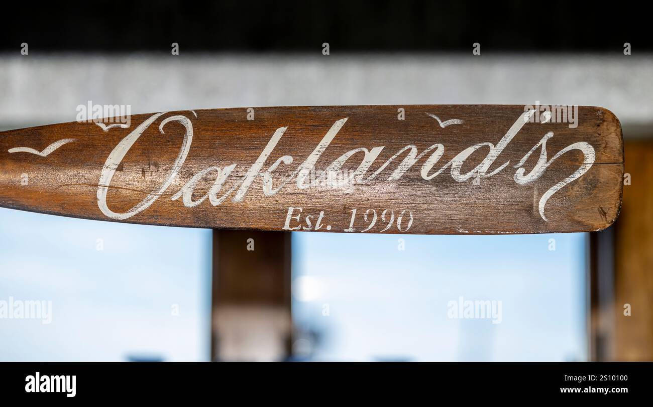 detail image of an old wooden oar with Oaklands, established in 1990 ...