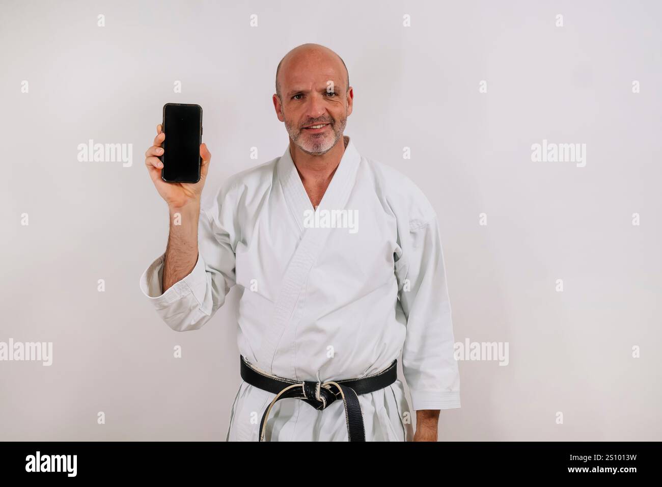 Karate master using a smartphone Stock Photo - Alamy