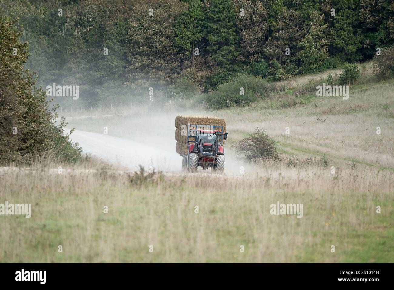 large red Case Puma 340 tractor towing a fully laden hay bale trailer ...