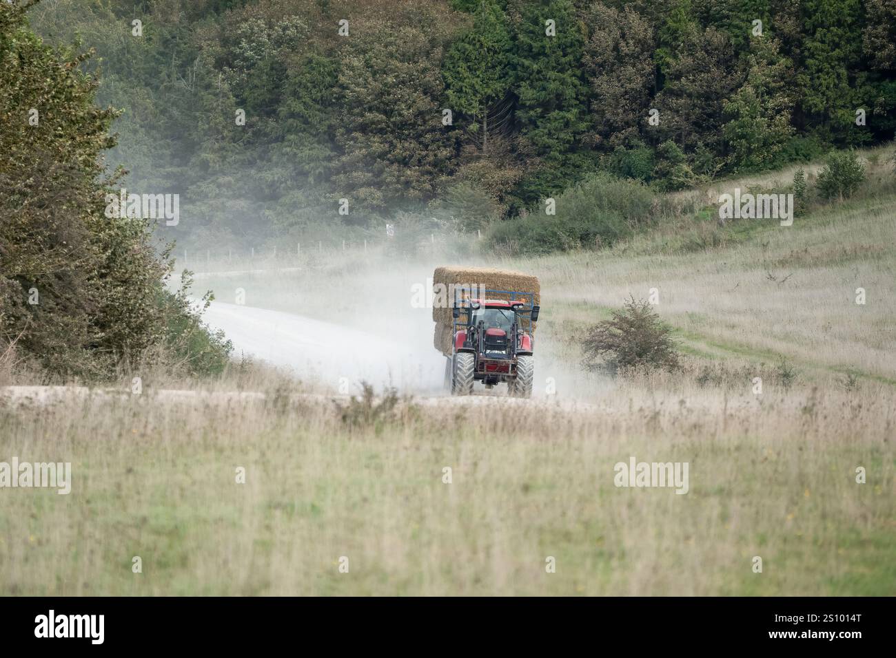 large red Case Puma 340 tractor towing a fully laden hay bale trailer ...