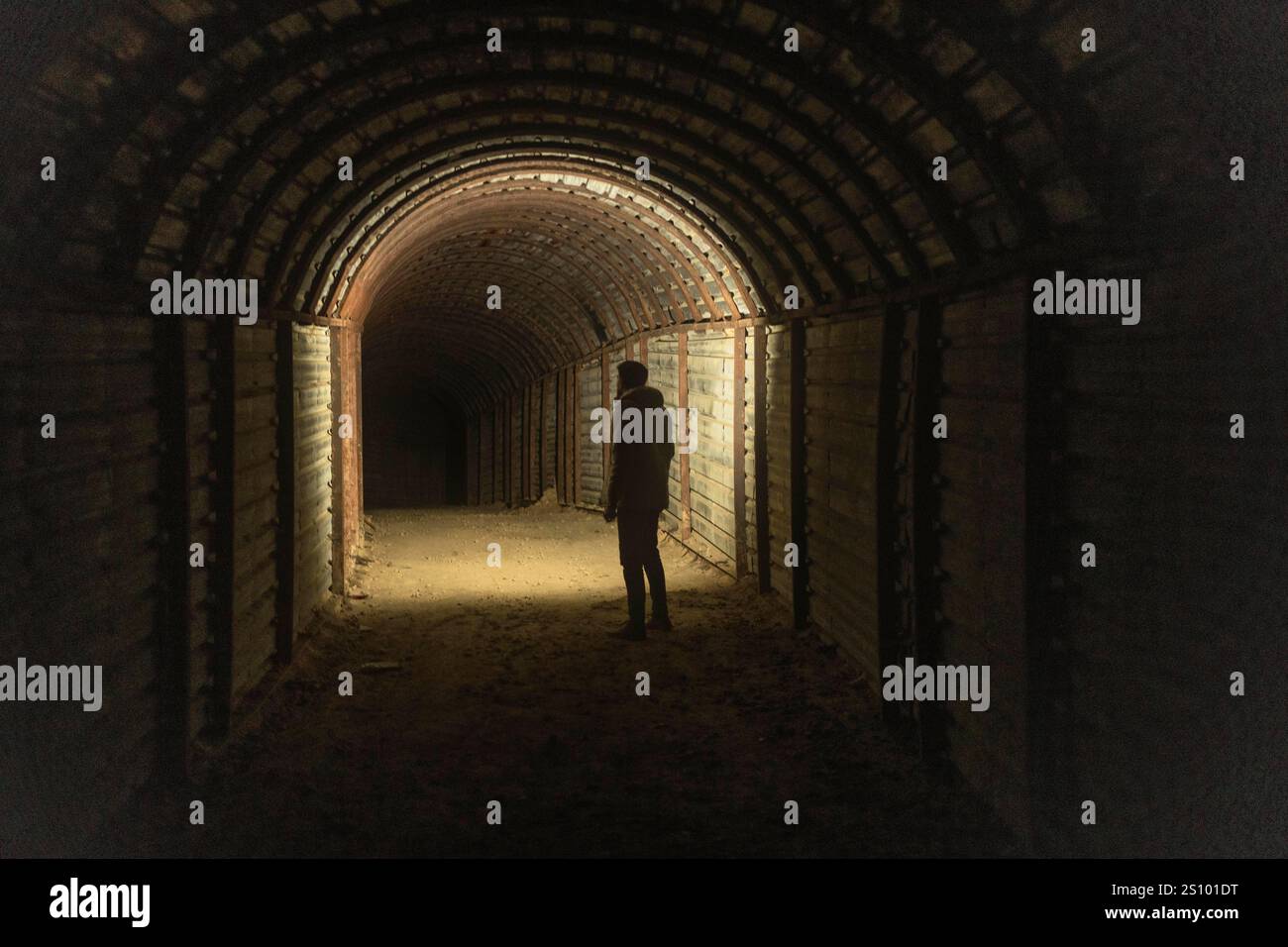 Dr. Mohammed Daher, a general practitioner, walks in a tunnel that was ...